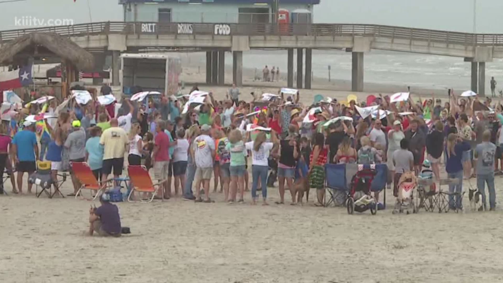Human peace sign formed on Port Aransas beach to celebrate Earth Day ...