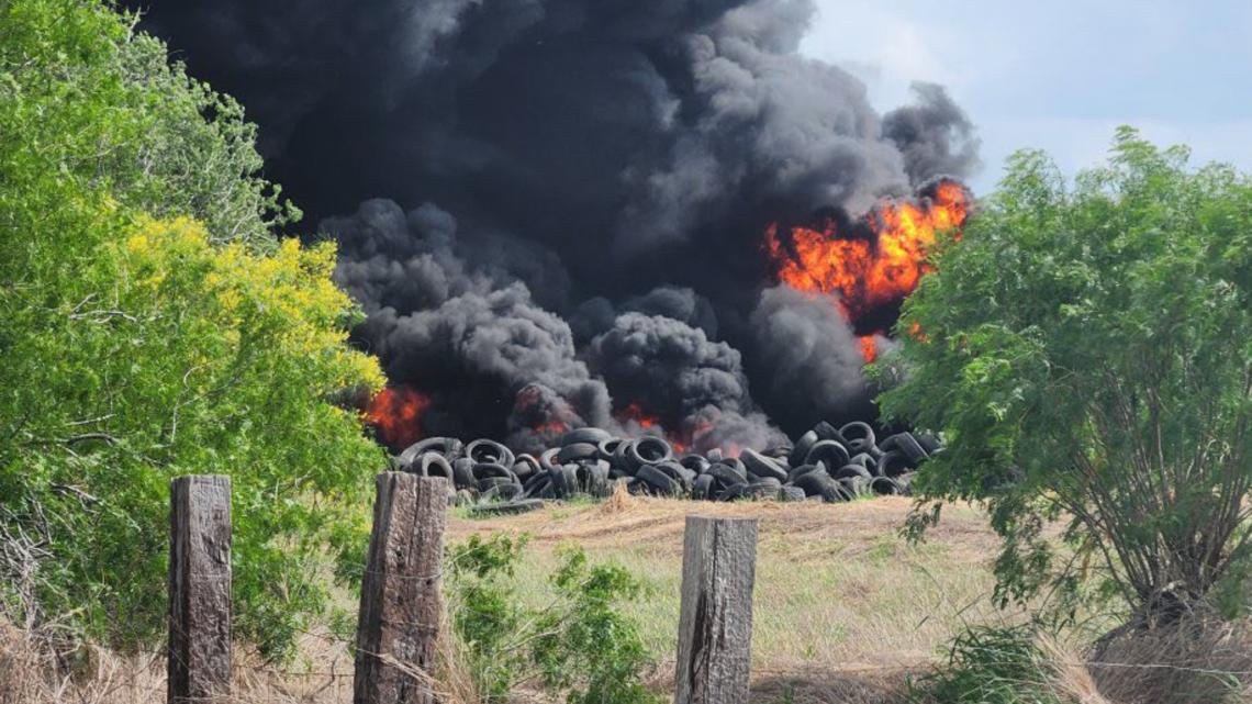 Fire in 'illegally' dumped tire pile sends dark smoke into air near ...
